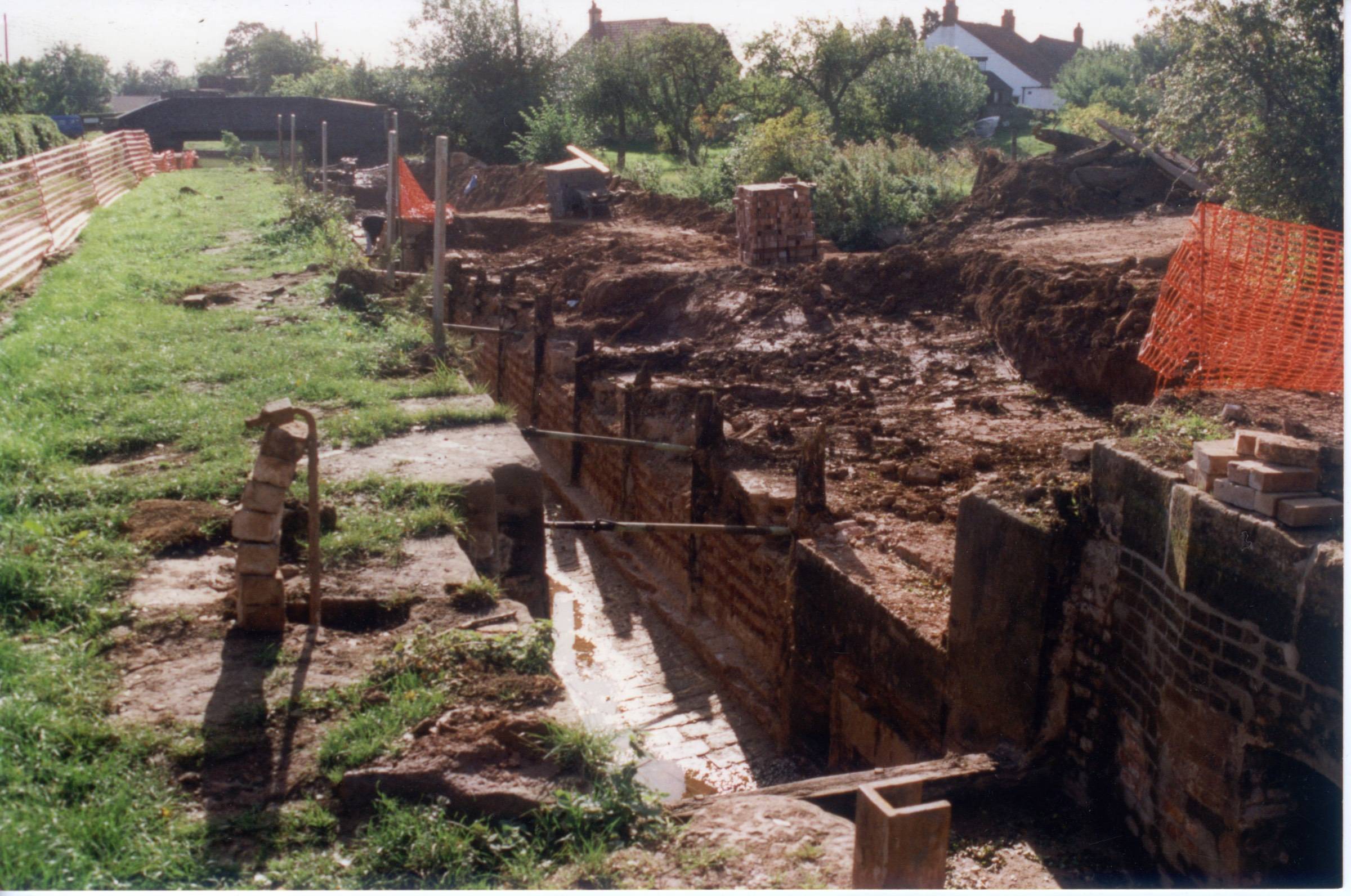 Wooden post behind lock wall. - History & Heritage - Canal World